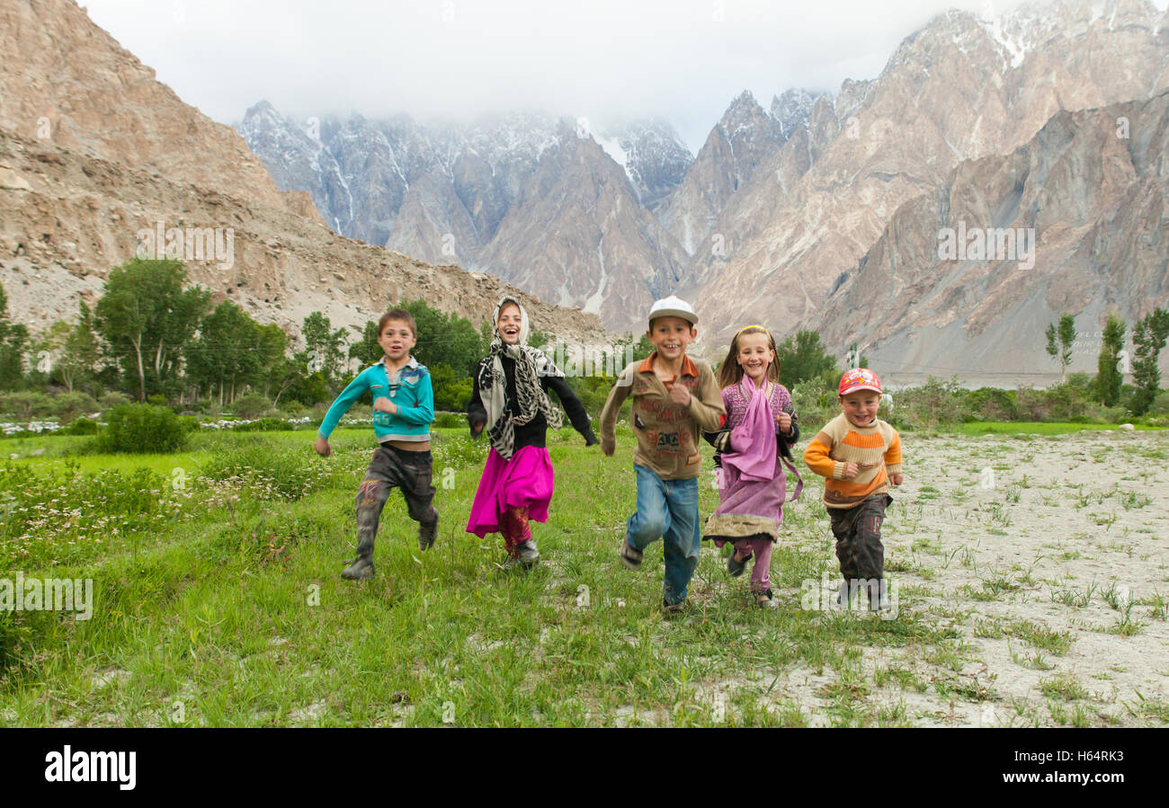 children running together in stunning scenery of Karakoram mountains in ...