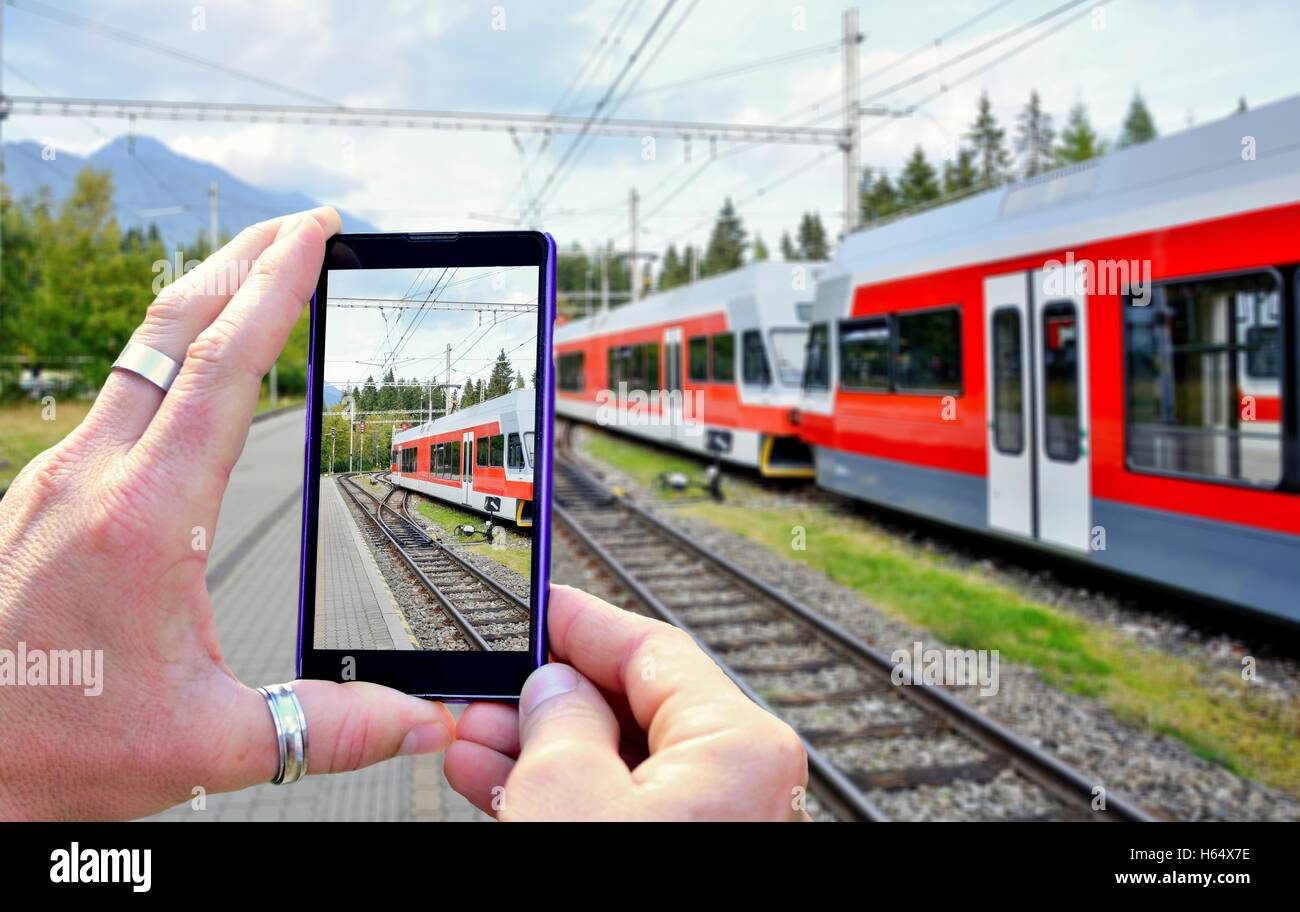 View over the mobile phone display during taking a picture of train at ...