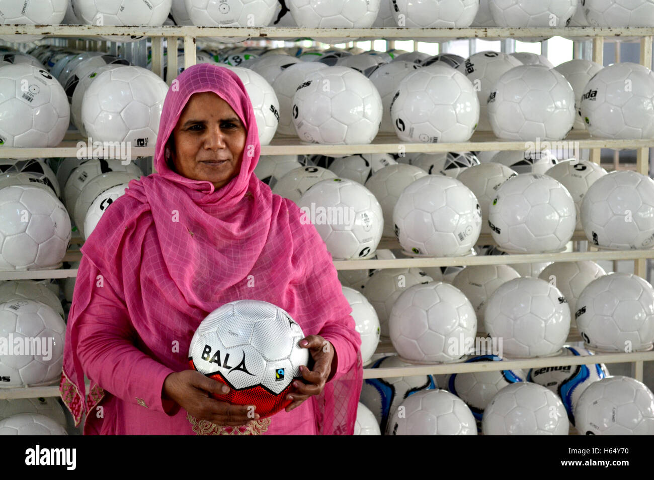 A Pakistani worker producer of fairtrade footballs in a sports ball ...