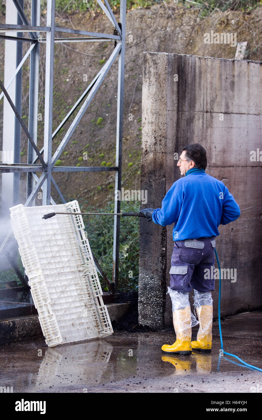worker cleaning industrial tool with a pressure cleaner Stock Photo - Alamy