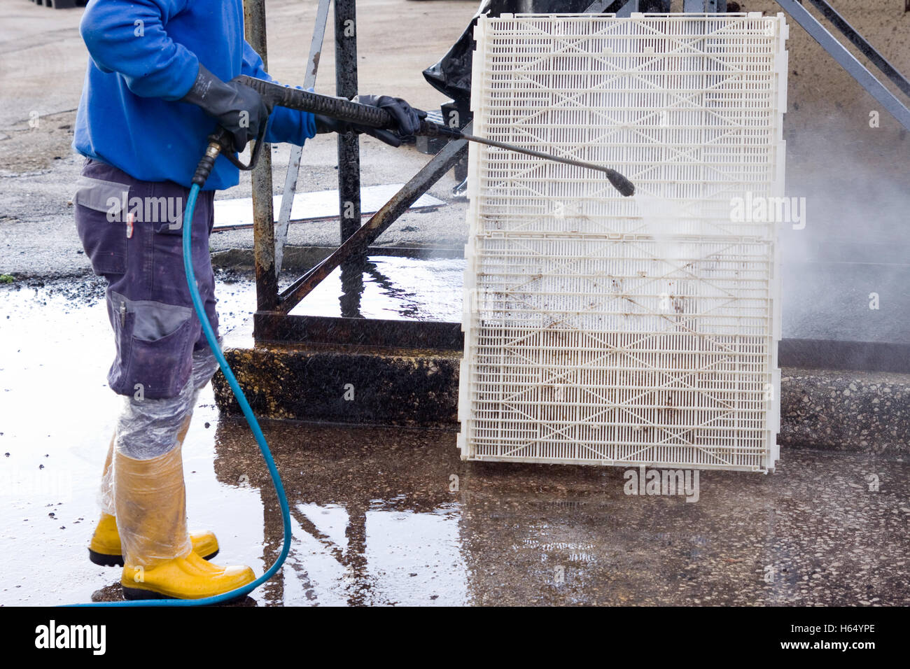 worker cleaning industrial tool with a pressure cleaner Stock Photo - Alamy