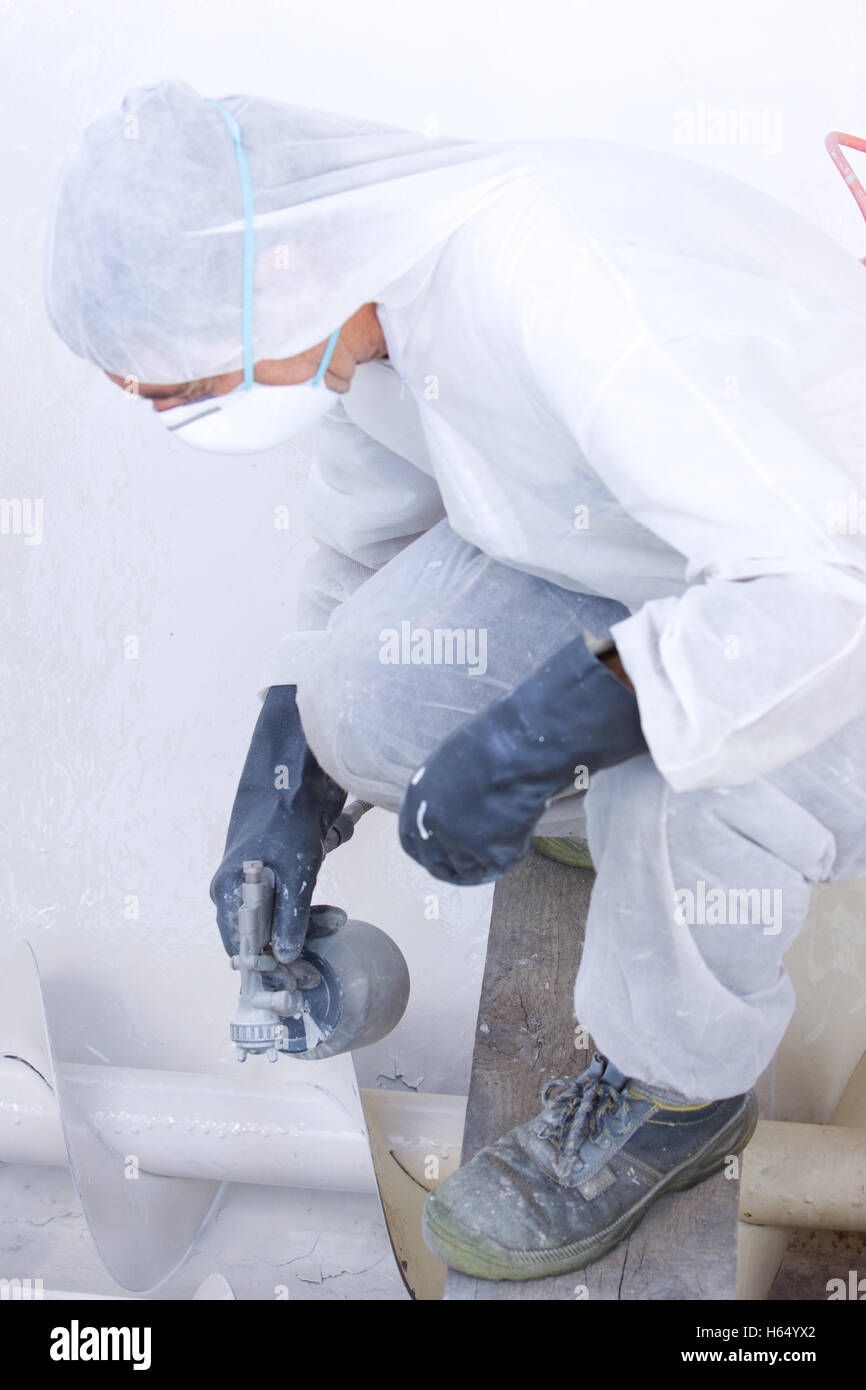 skilled worker painting industrial tool in a industry Stock Photo - Alamy