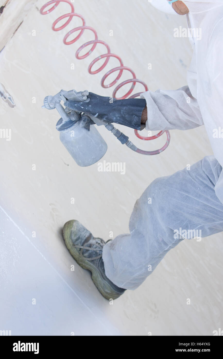 skilled worker painting industrial tool in a industry Stock Photo - Alamy