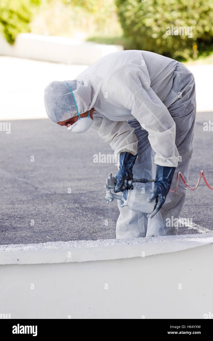 skilled worker painting industrial tool in a industry Stock Photo - Alamy