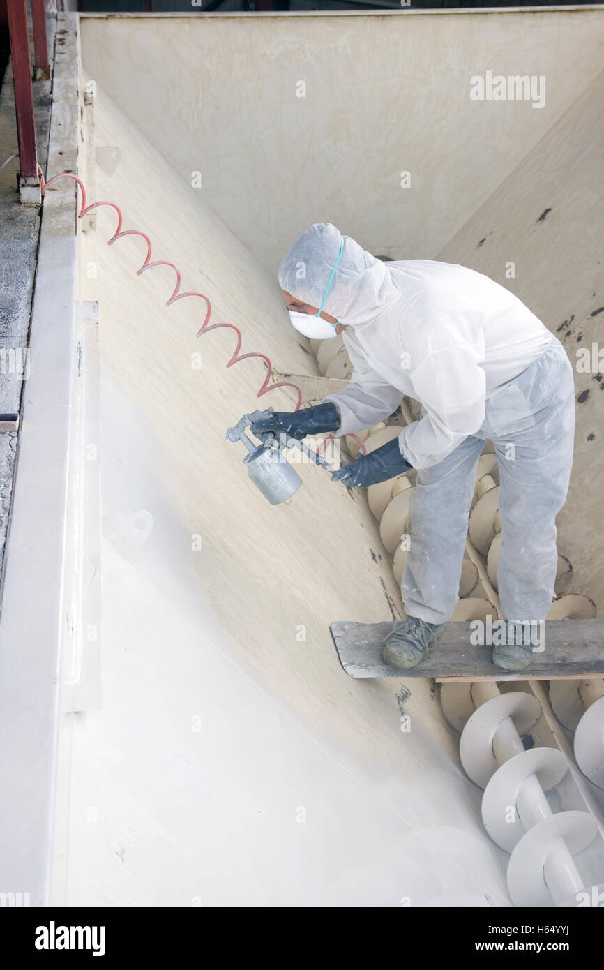 skilled worker painting industrial tool in a industry Stock Photo - Alamy