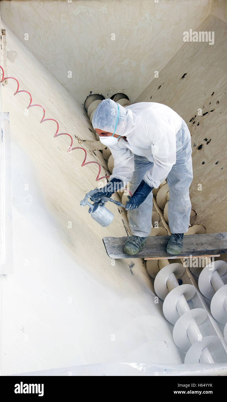 skilled worker painting industrial tool in a industry Stock Photo - Alamy