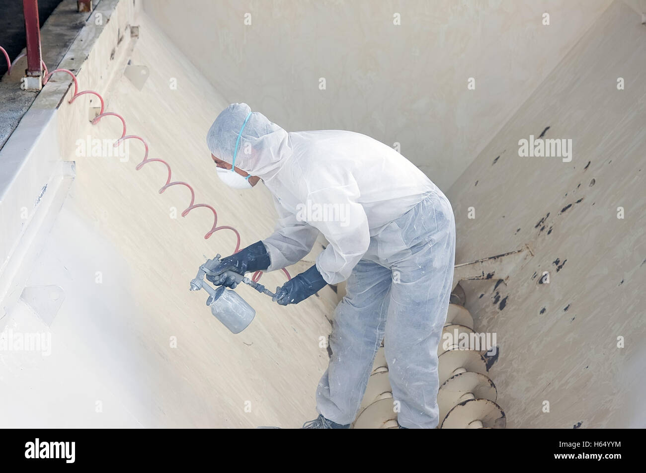 skilled worker painting industrial tool in a industry Stock Photo - Alamy