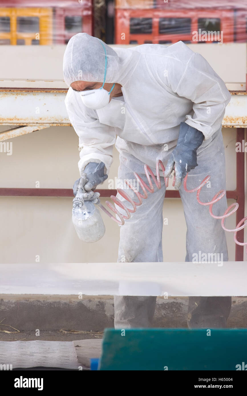 skilled worker painting industrial tool in a industry Stock Photo - Alamy