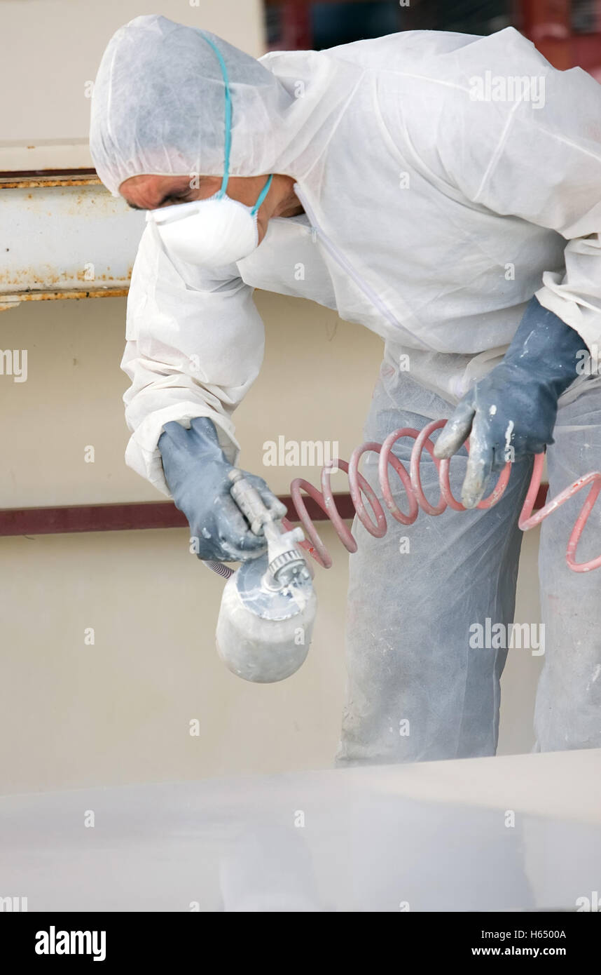 skilled worker painting industrial tool in a industry Stock Photo - Alamy