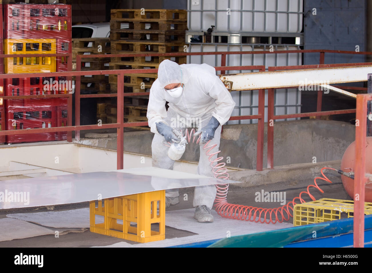 skilled worker painting industrial tool in a industry Stock Photo - Alamy