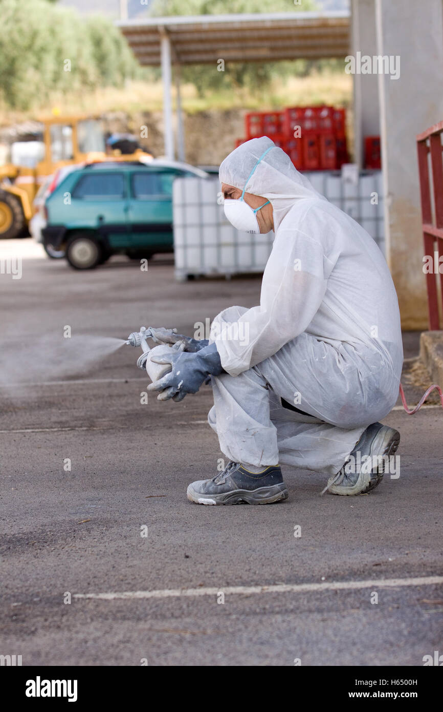 skilled worker painting industrial tool in a industry Stock Photo - Alamy