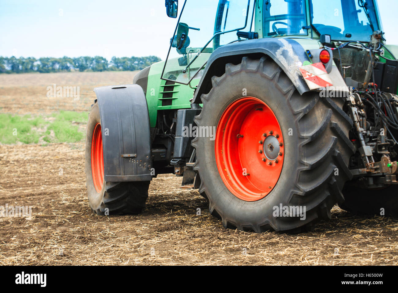 Rural landscape with a tractor in a field Stock Photo - Alamy