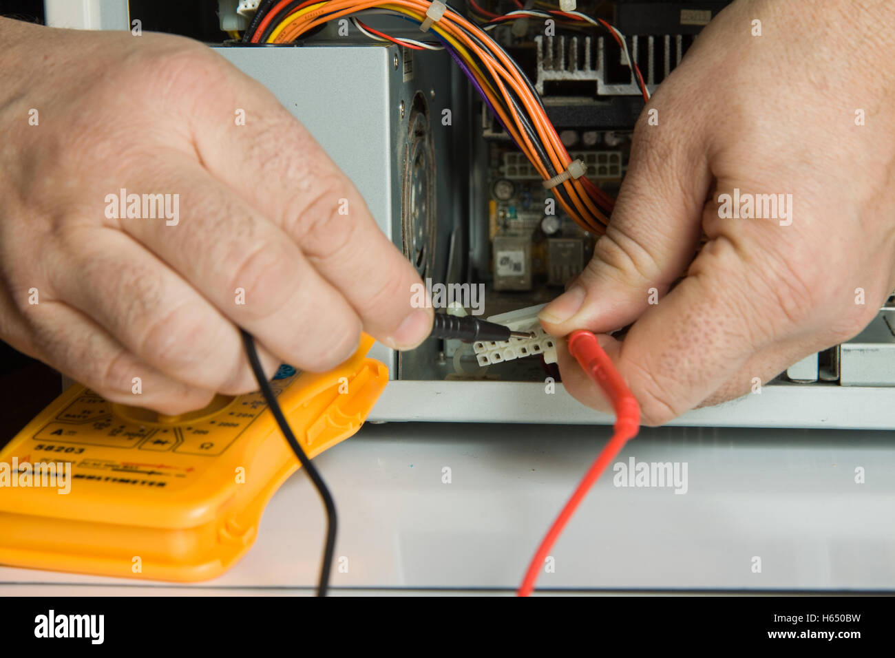 electrician at work with an electric device Stock Photo - Alamy