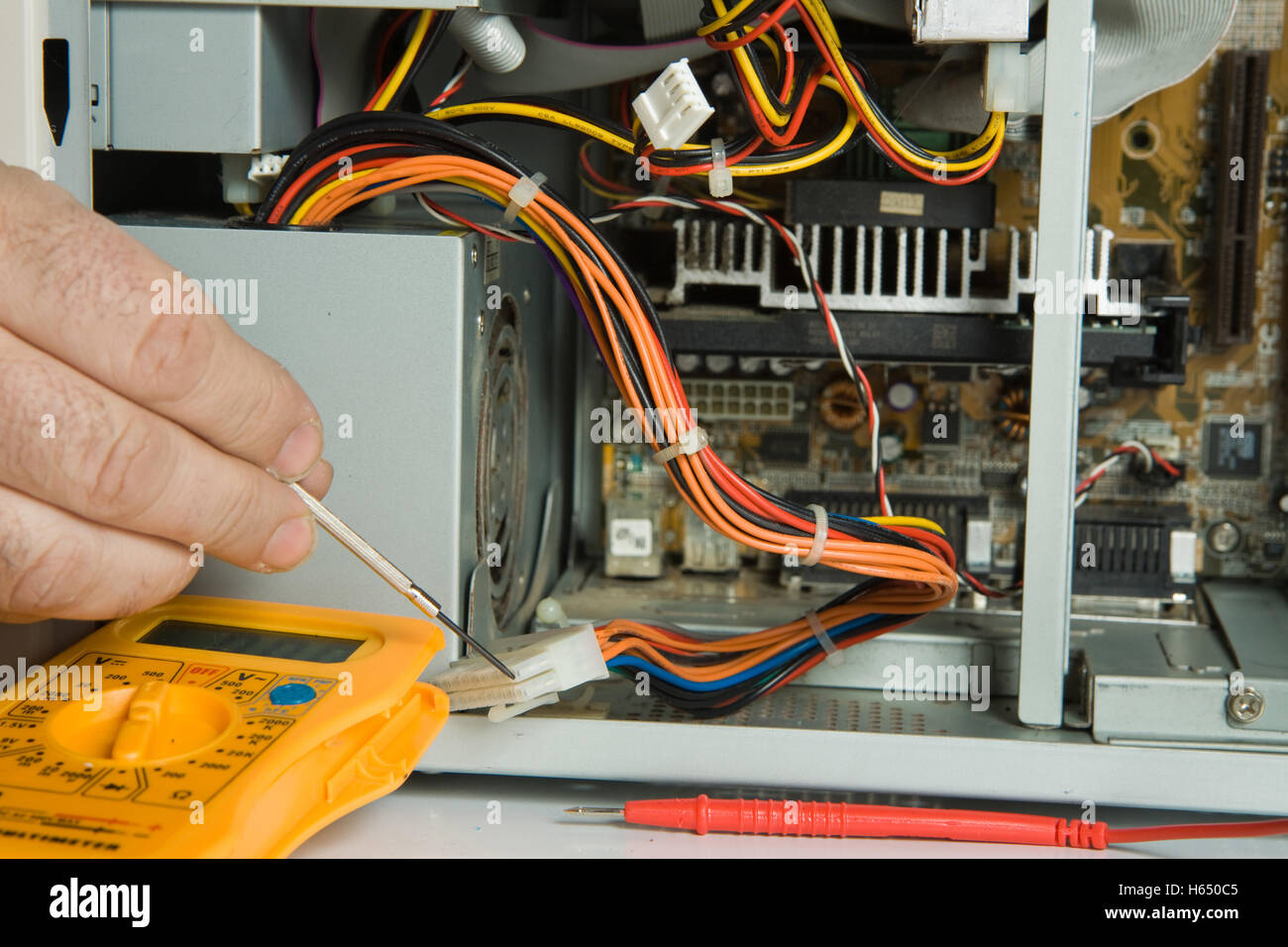 electrician at work with an electric device Stock Photo - Alamy