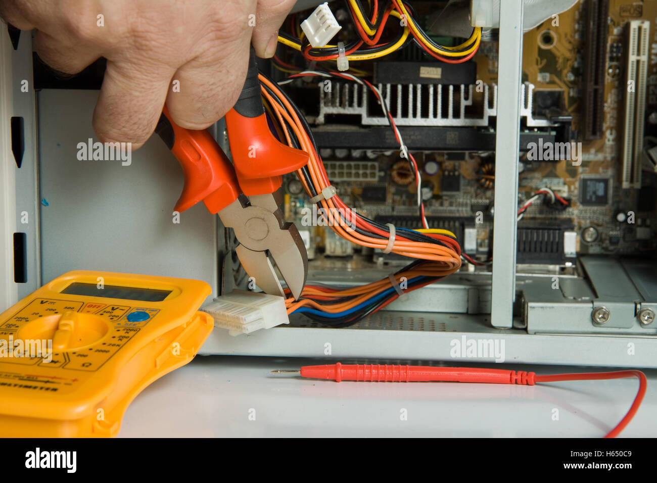 electrician at work with an electric device Stock Photo - Alamy