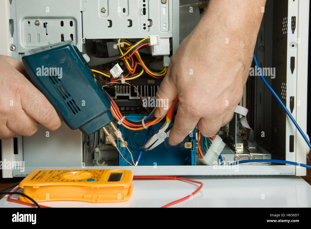 electrician at work with an electric device Stock Photo - Alamy