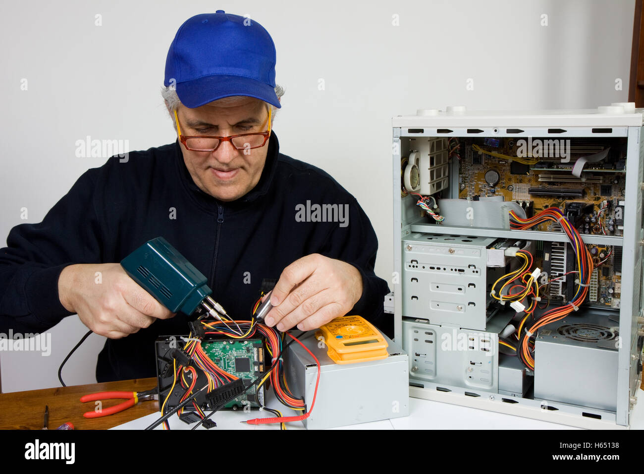 electrician at work with an electronic device Stock Photo - Alamy
