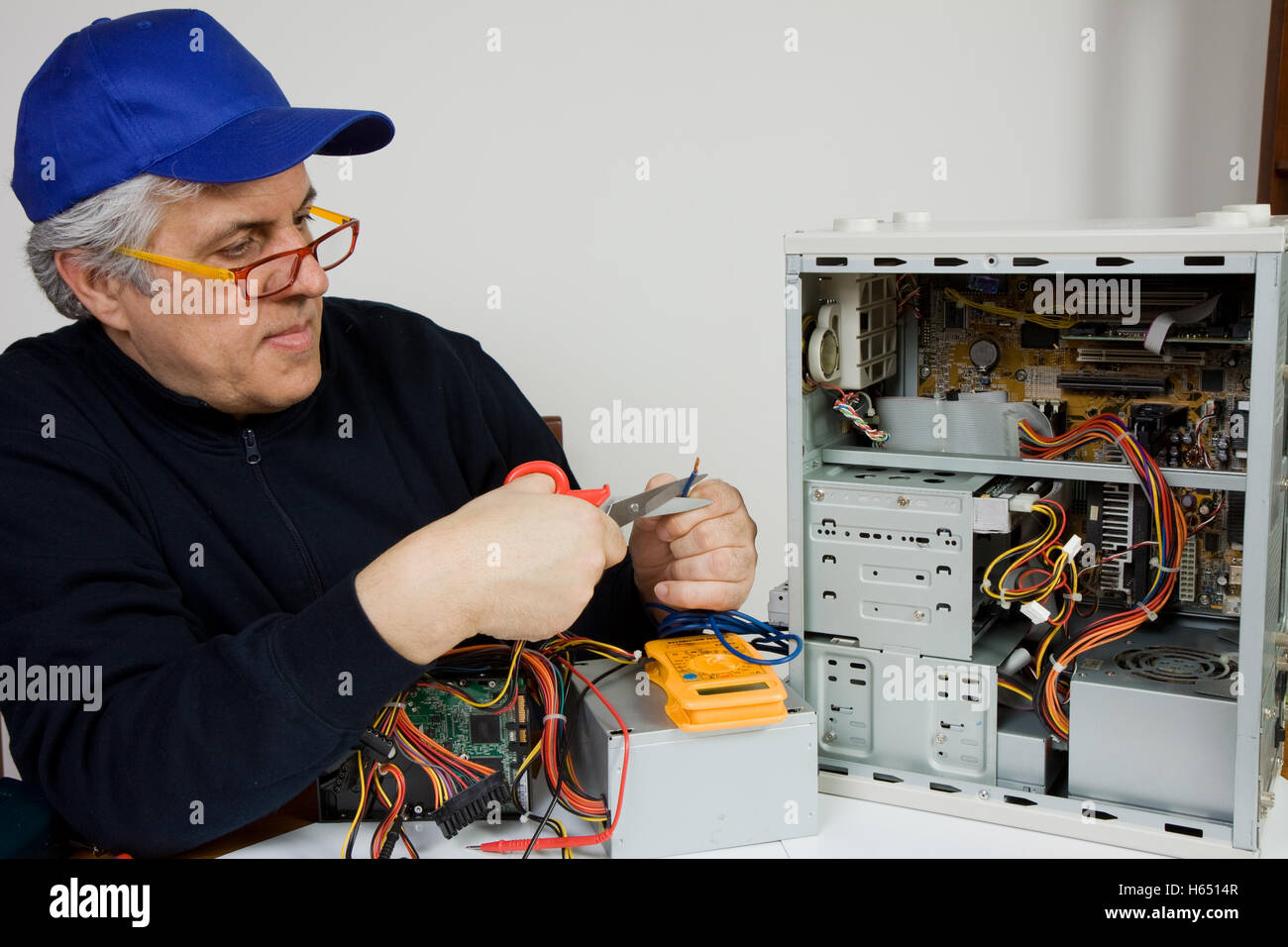 electrician at work with an electronic device Stock Photo - Alamy