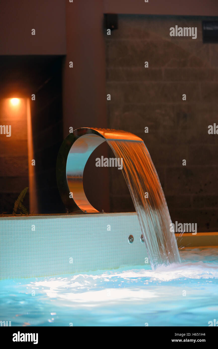Relaxation pool in spa with waterfall Stock Photo - Alamy