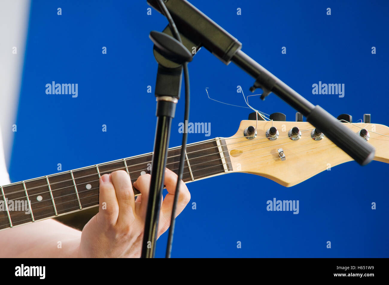 guitarist during the live performance on stage Stock Photo - Alamy