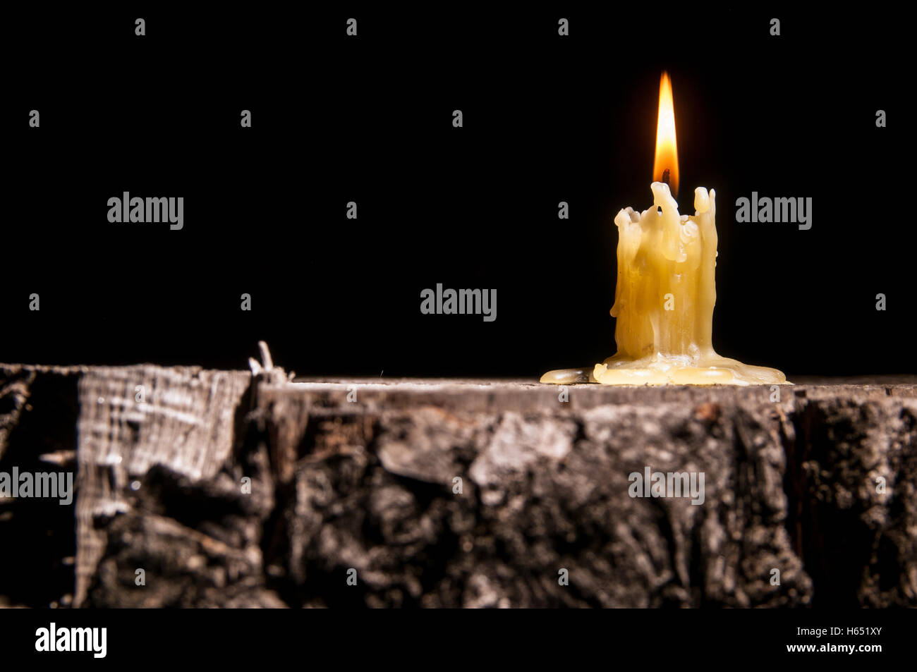 Candle burning on a tree stump hi-res stock photography and images - Alamy