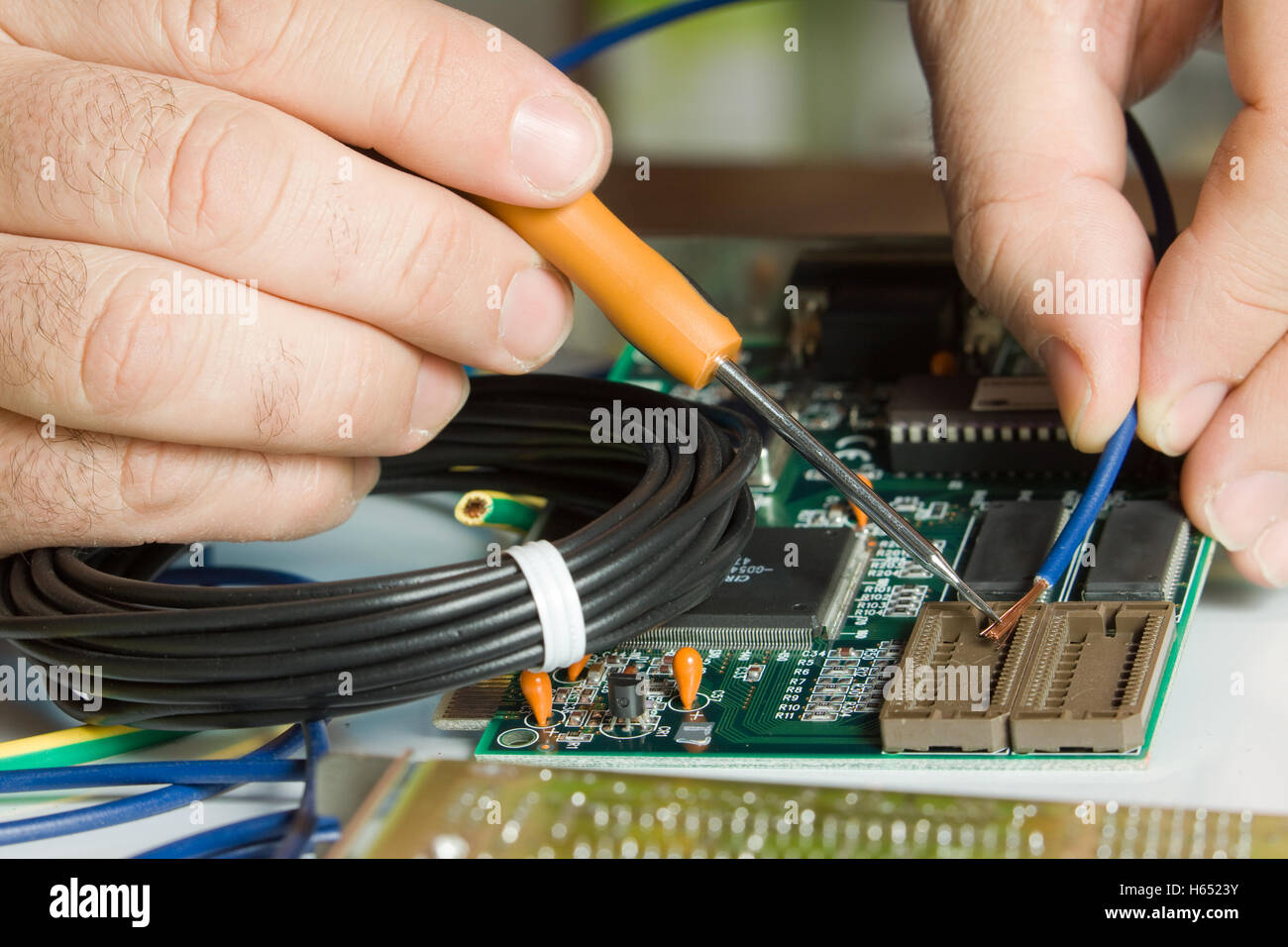 electrician at work with an electric appliance Stock Photo - Alamy