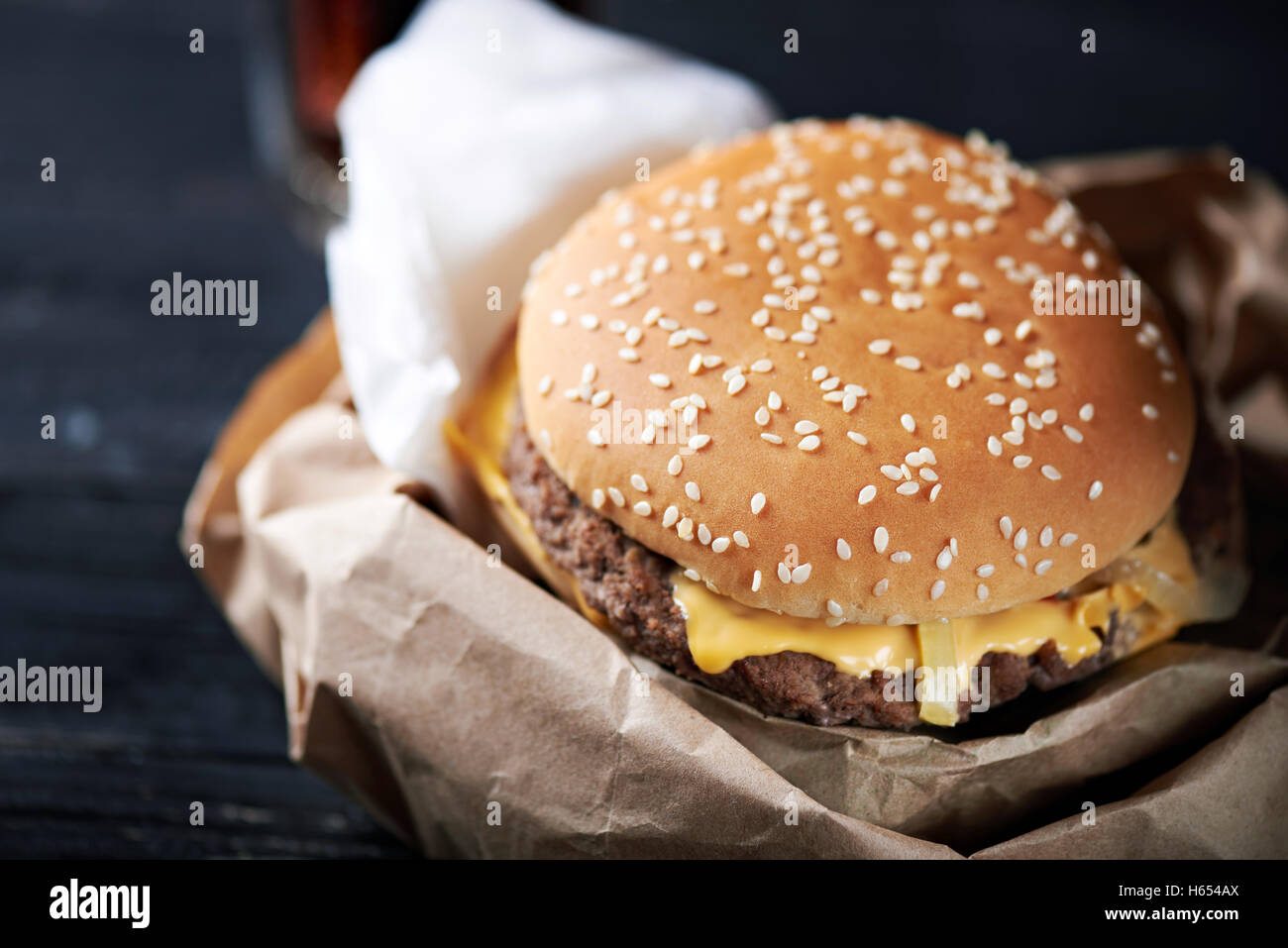 Unhealthy cheeseburger in the paper container Stock Photo - Alamy
