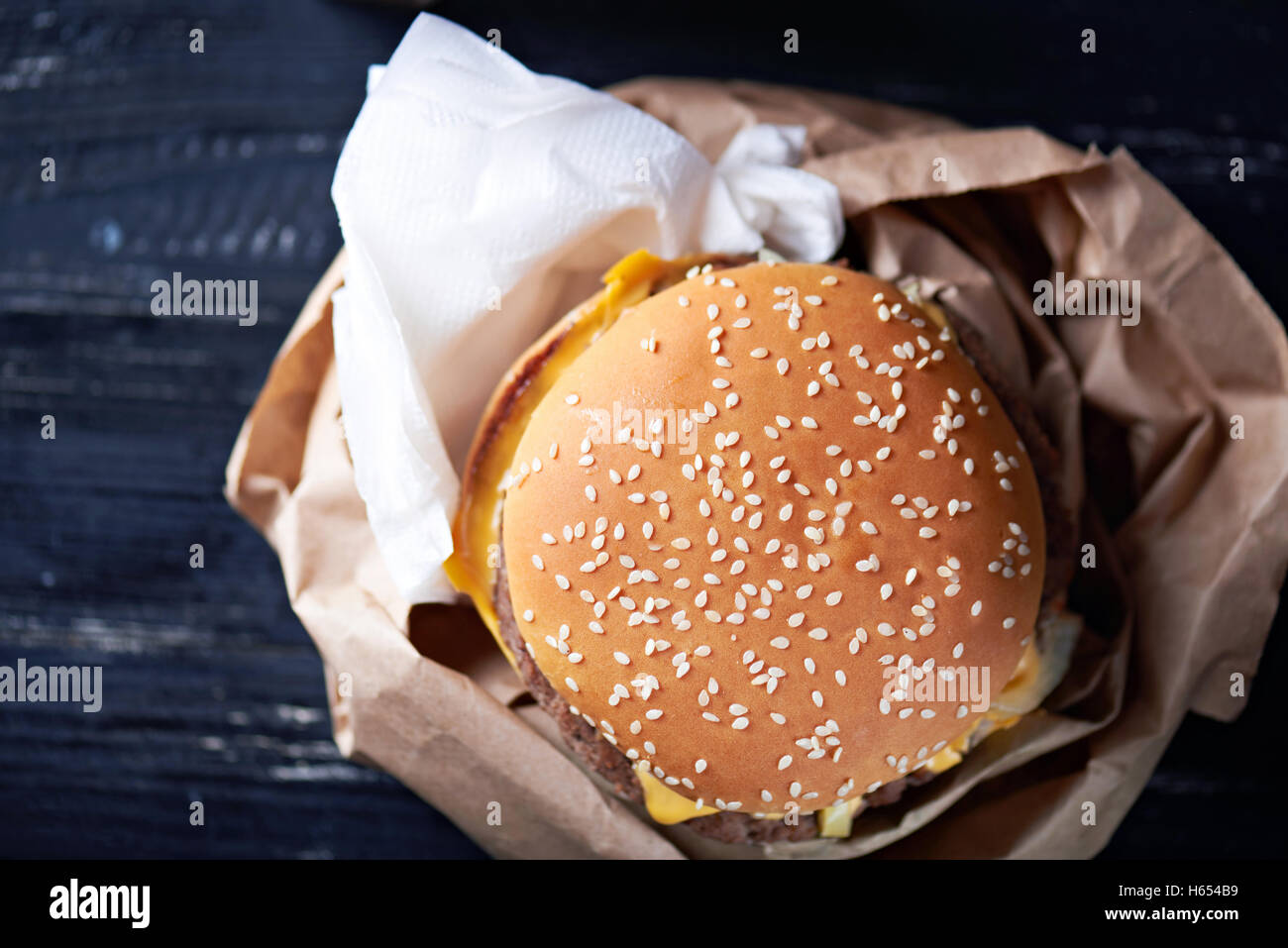 Unhealthy cheeseburger in the paper container Stock Photo - Alamy
