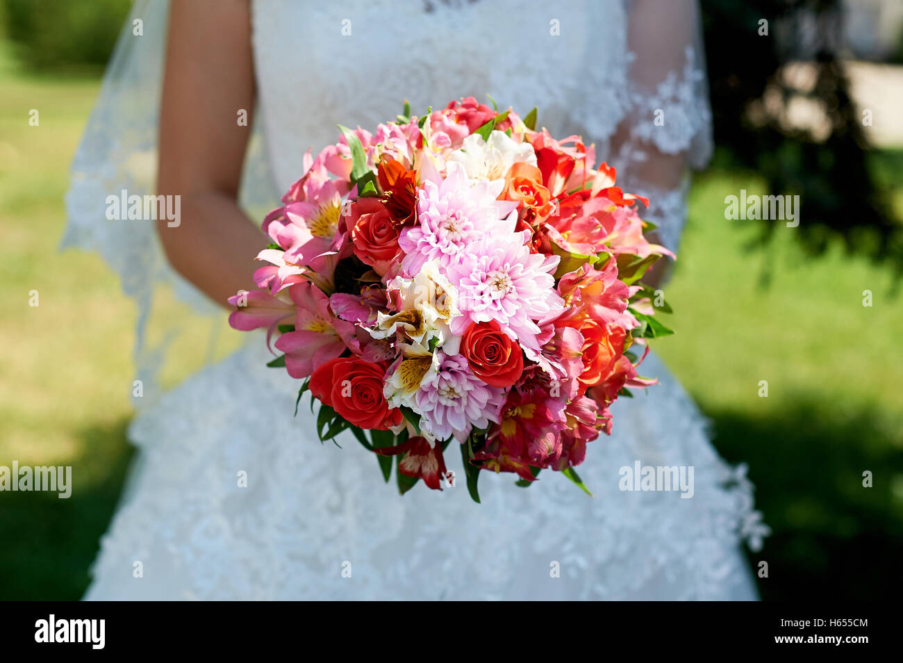 Bride holding big wedding bouquet on ceremony Stock Photo - Alamy