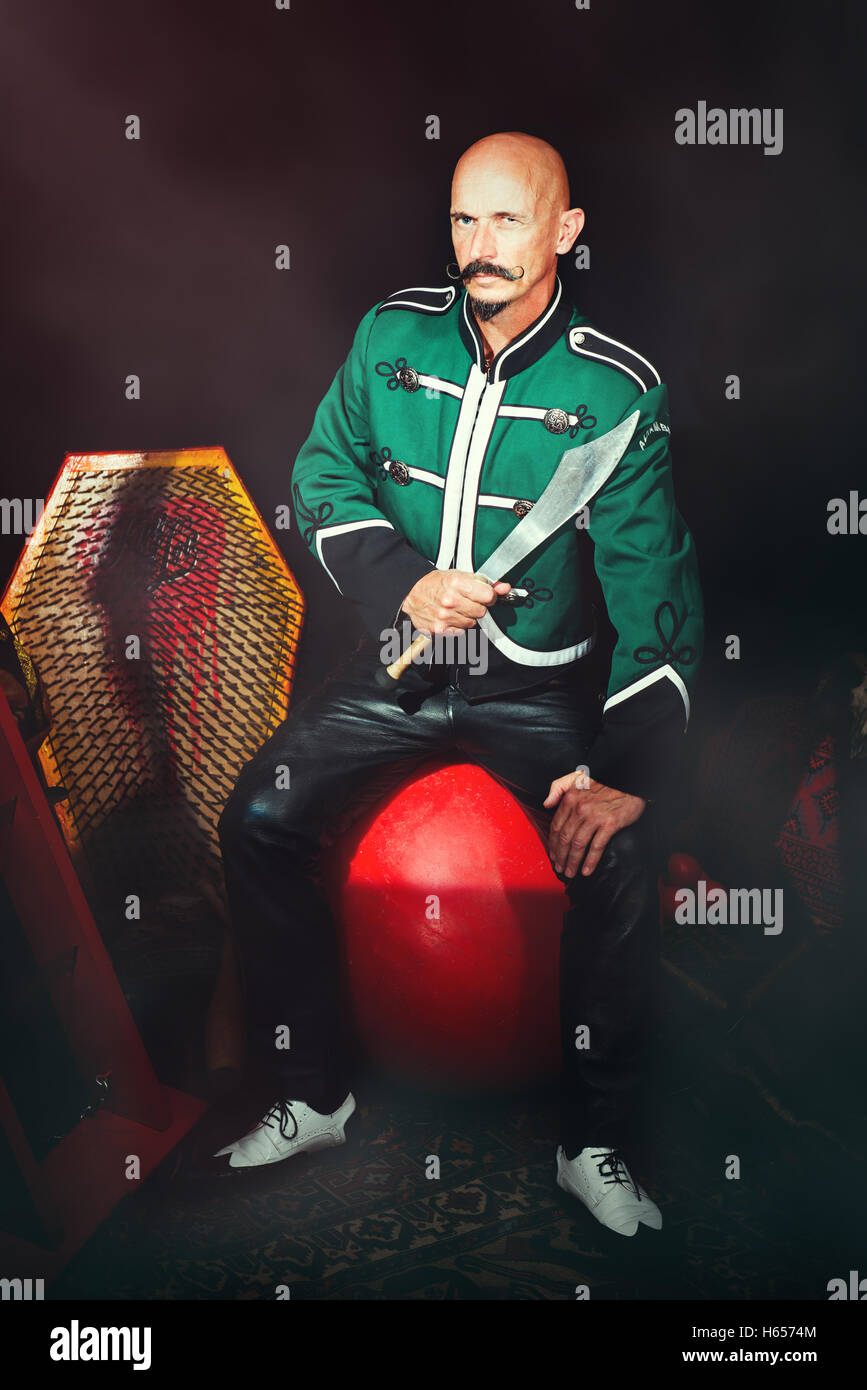 Circus performer holding a sword Stock Photo - Alamy