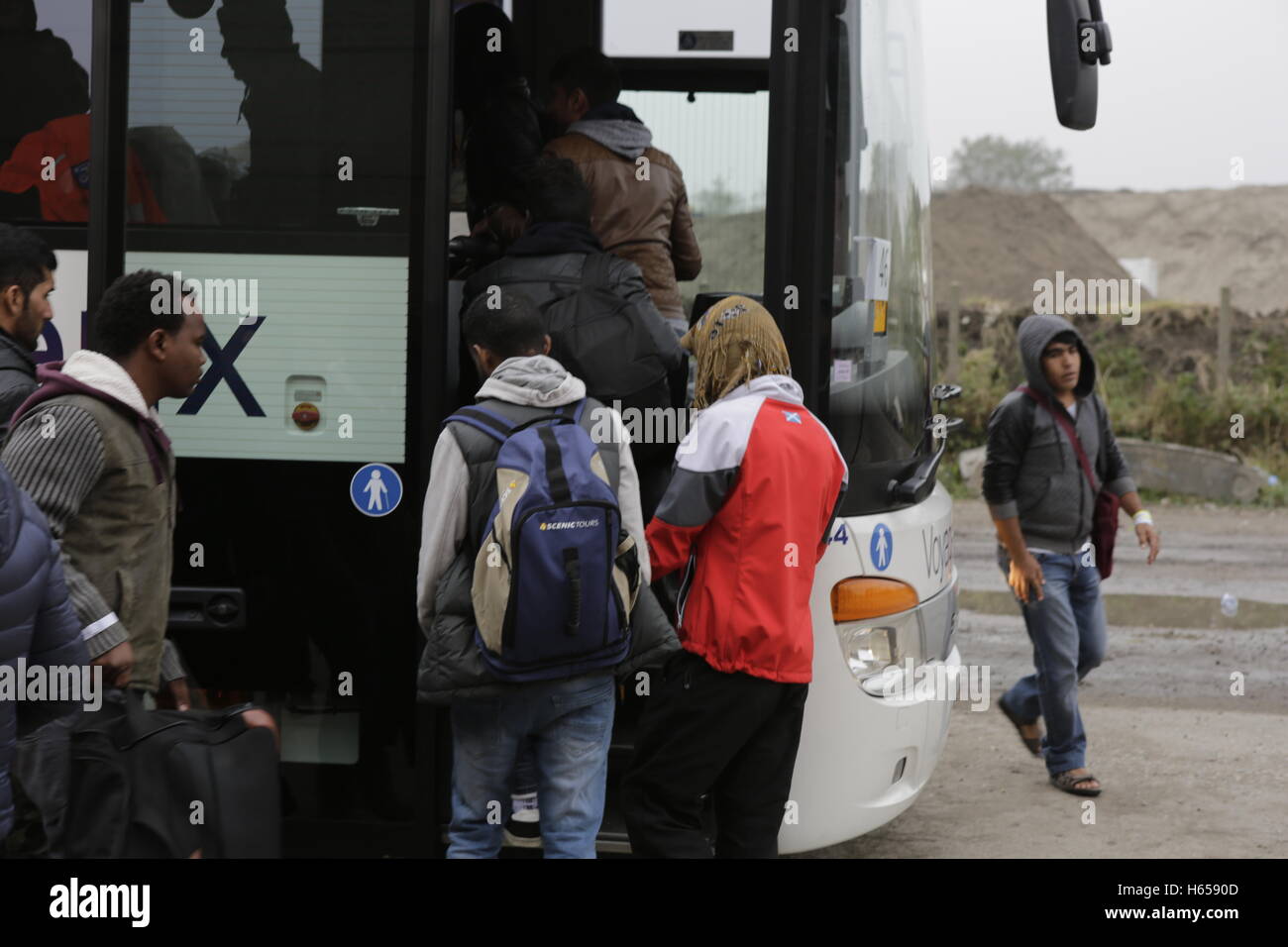 Calais, France. 24th October 2016. Refugees board the bus that will ...