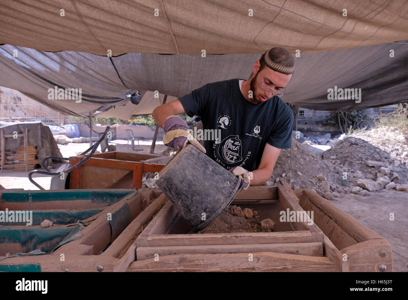 A Religious Jewish volunteer sorting through debris that was removed ...