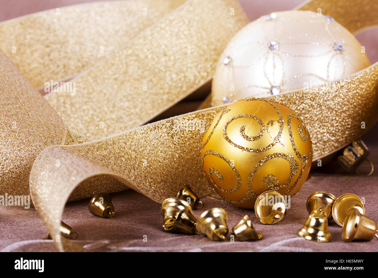 Festive gold Christmas decorations on a fabric background Stock Photo ...