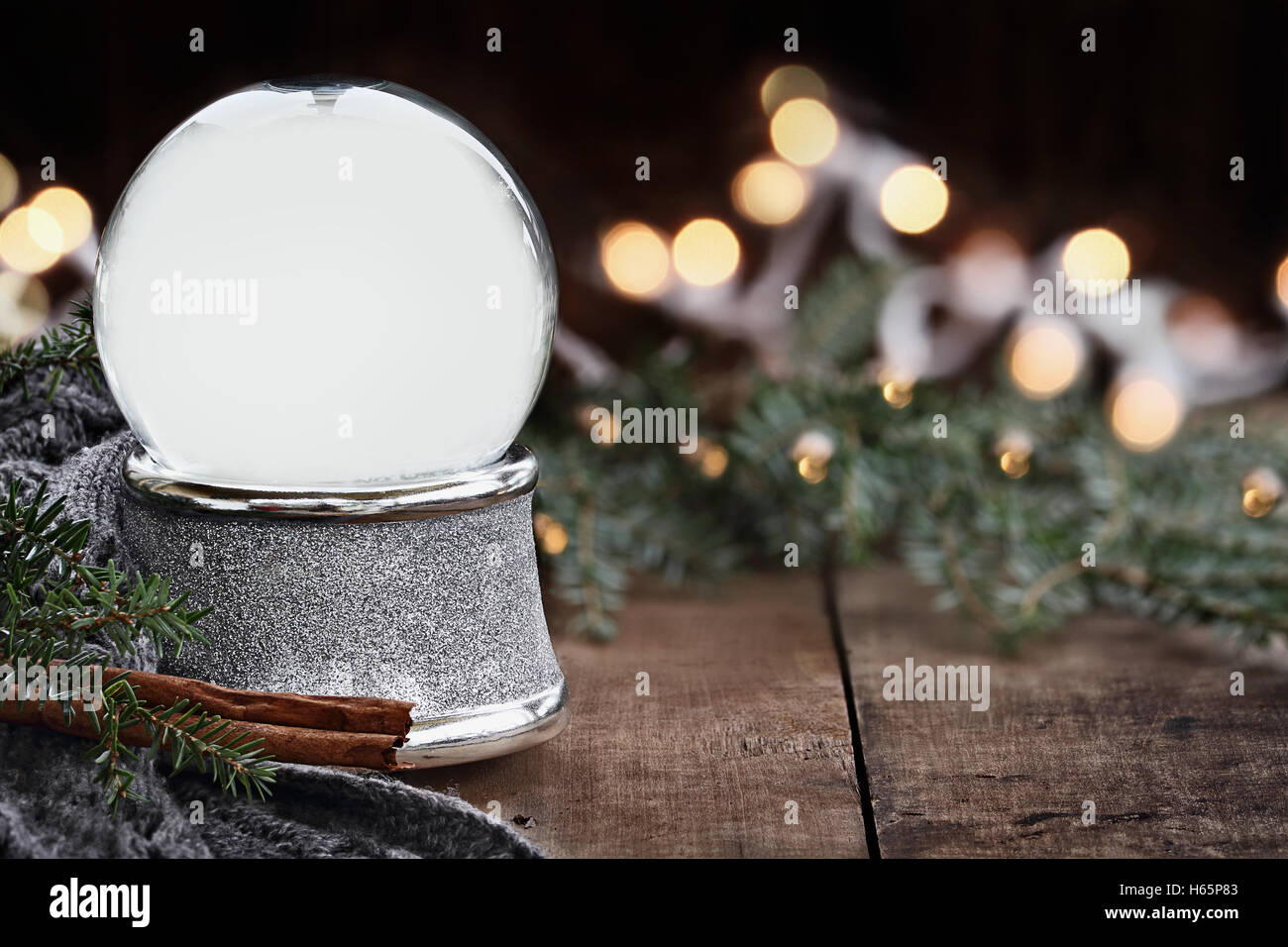 Rustic image of an empty snow globe surrounded by pine branches ...