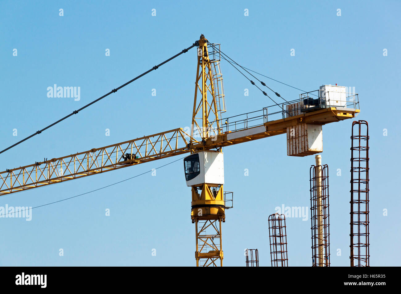High rise crane against blue sky operating at construction site Stock ...