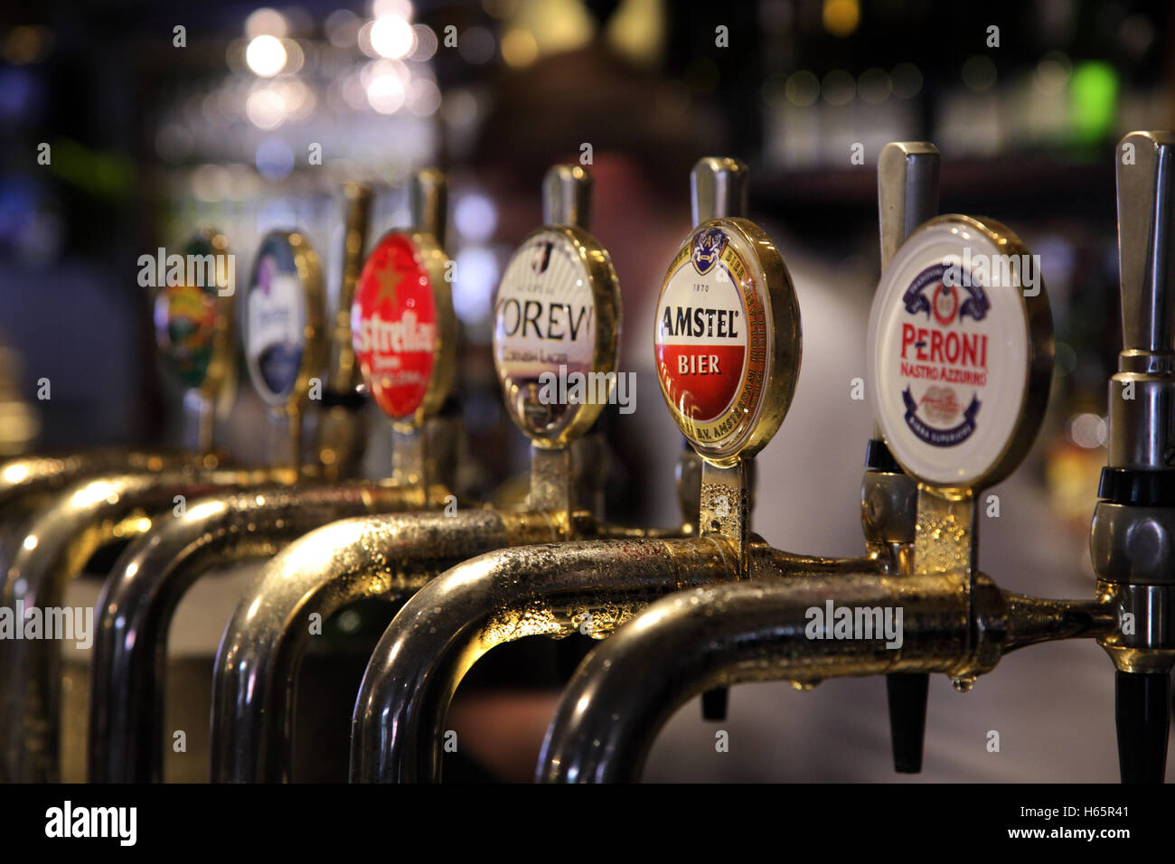 Row of lager and beer taps on a pub bar, Peroni, Amstel, Korev ...