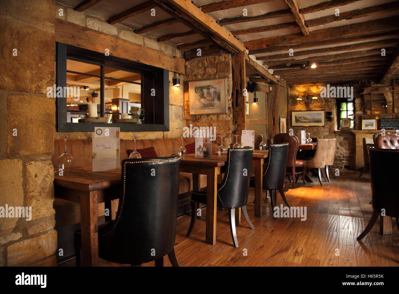 Interior of a country pub, with wooden floor, beams, olde worlde ...