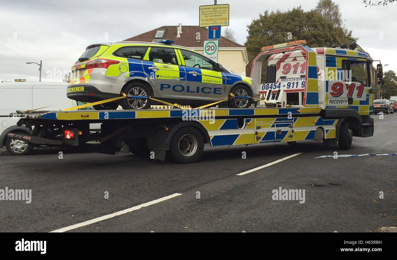 A police car with damage to the driver side is loaded on to a recovery ...