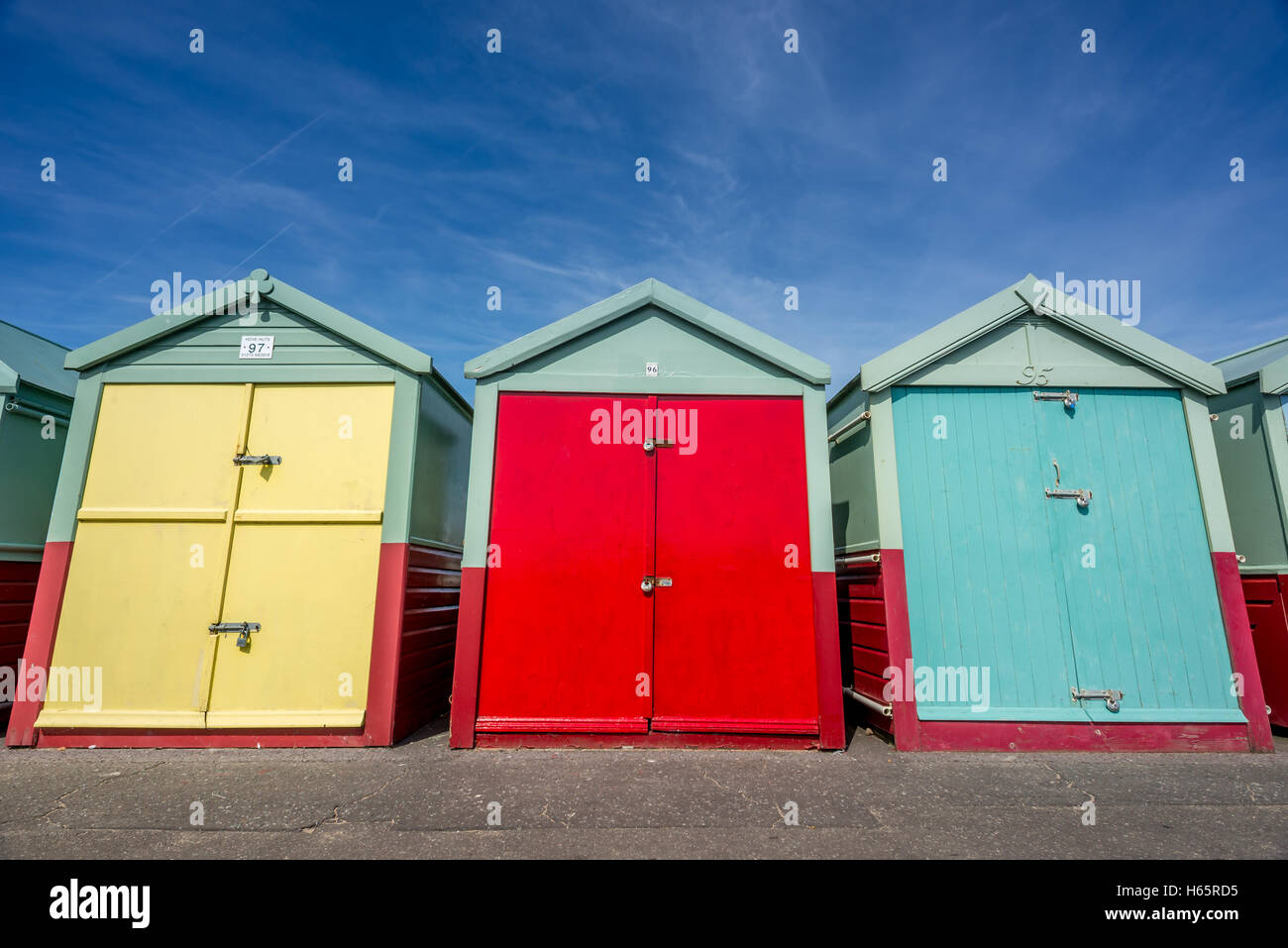 Bright colourful beach huts on the seafront at Brighton Stock Photo - Alamy