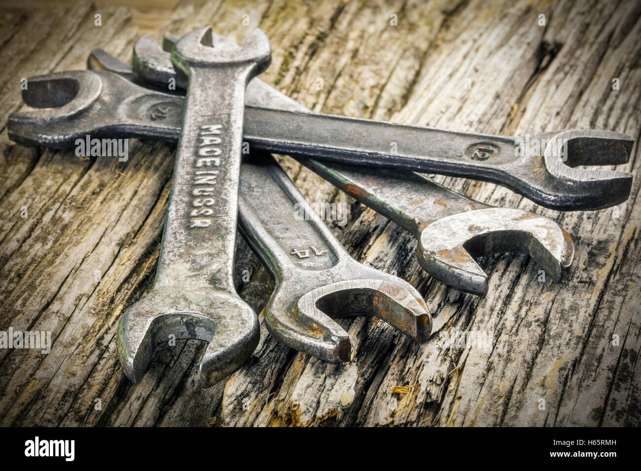 Rusty vintage metallic spanners on wooden table Stock Photo - Alamy