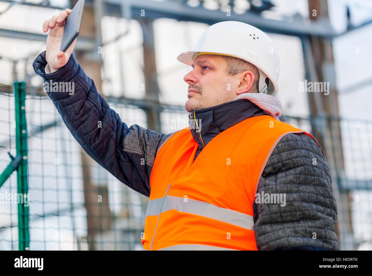 Electrical Engineer with tablet PC take a picture Stock Photo - Alamy