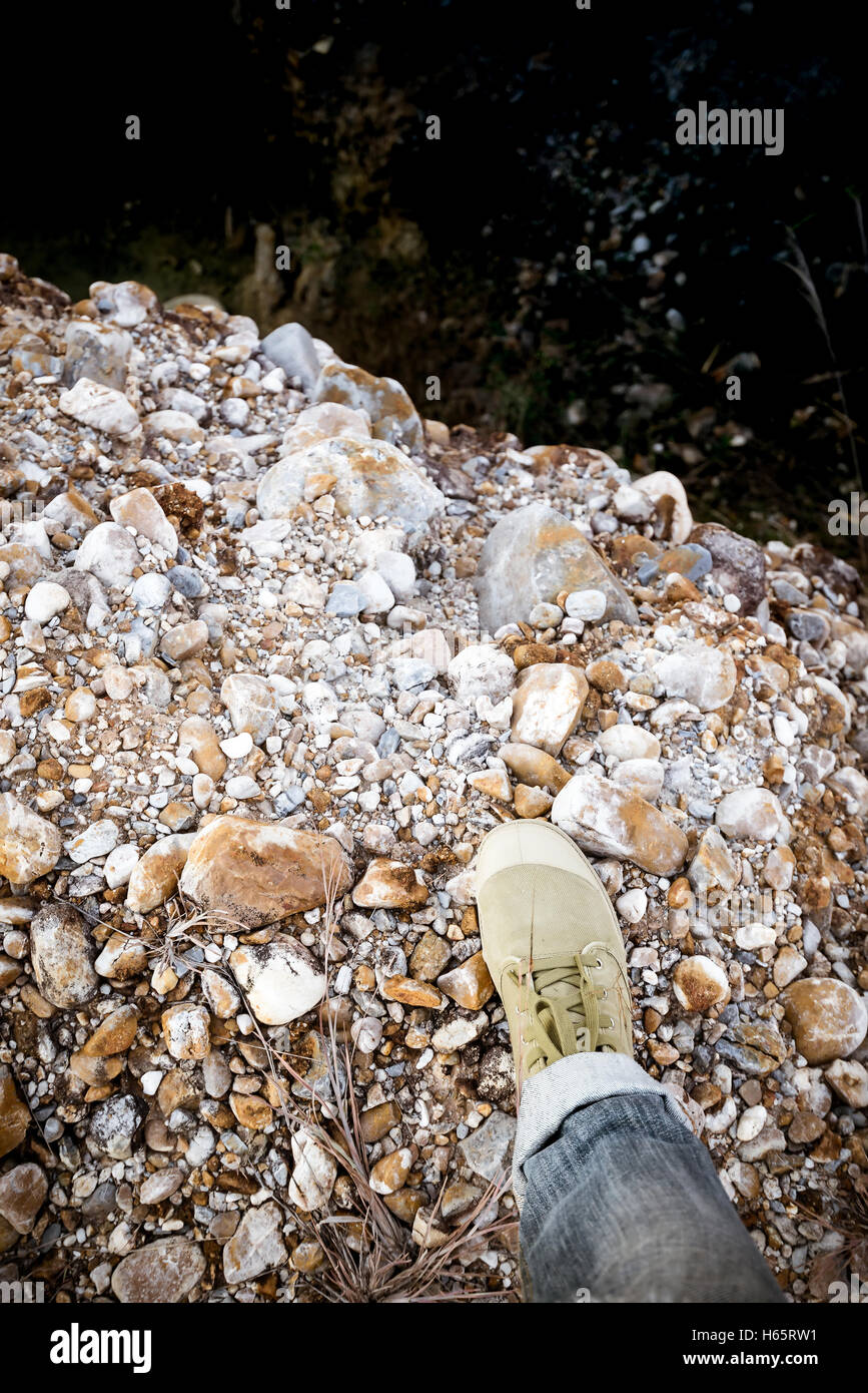 Man standing on cliff ledge looking down at the deep valley Stock Photo ...