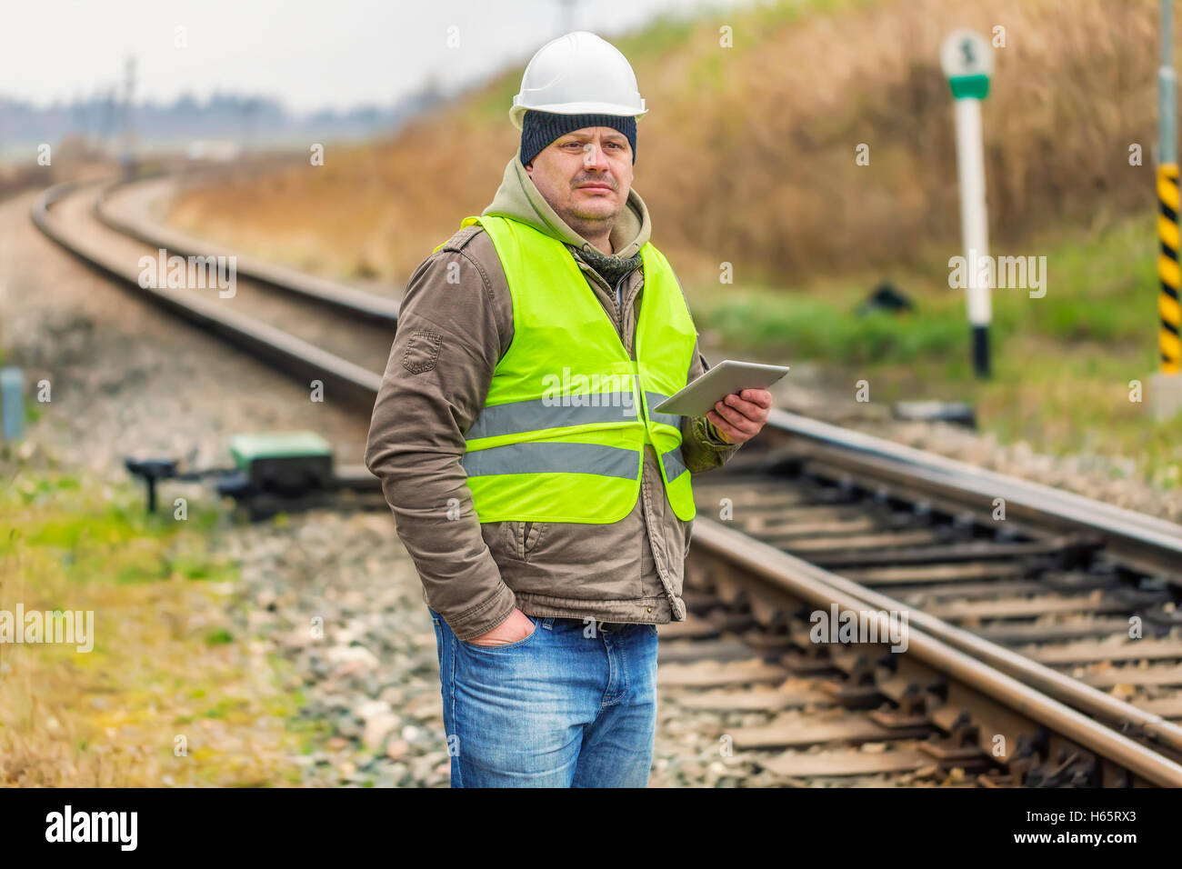 Railway employee with tablet PC near railway Stock Photo - Alamy
