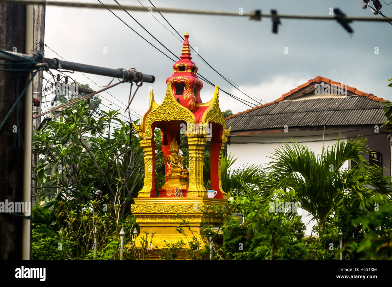 small golden buddhistic spirit house in tropical nature Stock Photo - Alamy