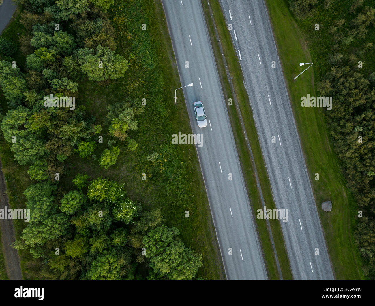 Top view of single car driving alone on the road, Reykjavik, Iceland ...