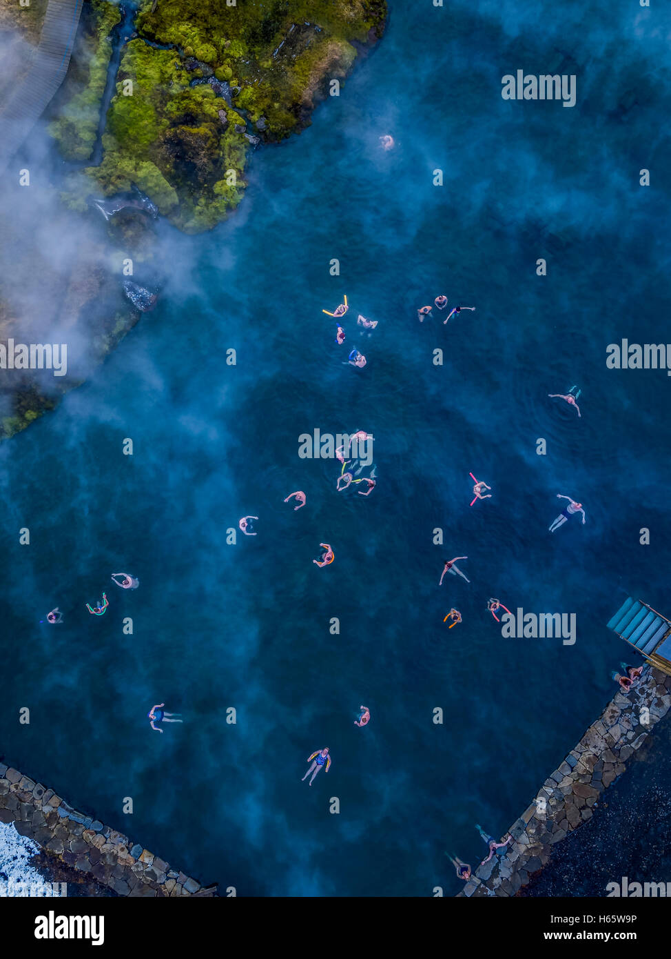 Aerial-People swimming in a natural hot spring- The Secret Lagoon ...