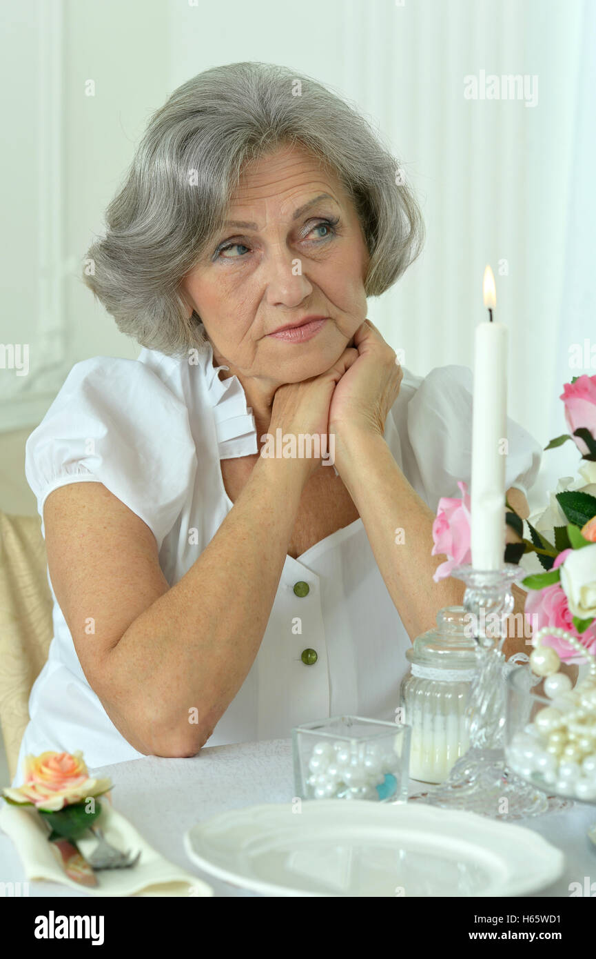 Elderly woman flowers table hi-res stock photography and images - Alamy