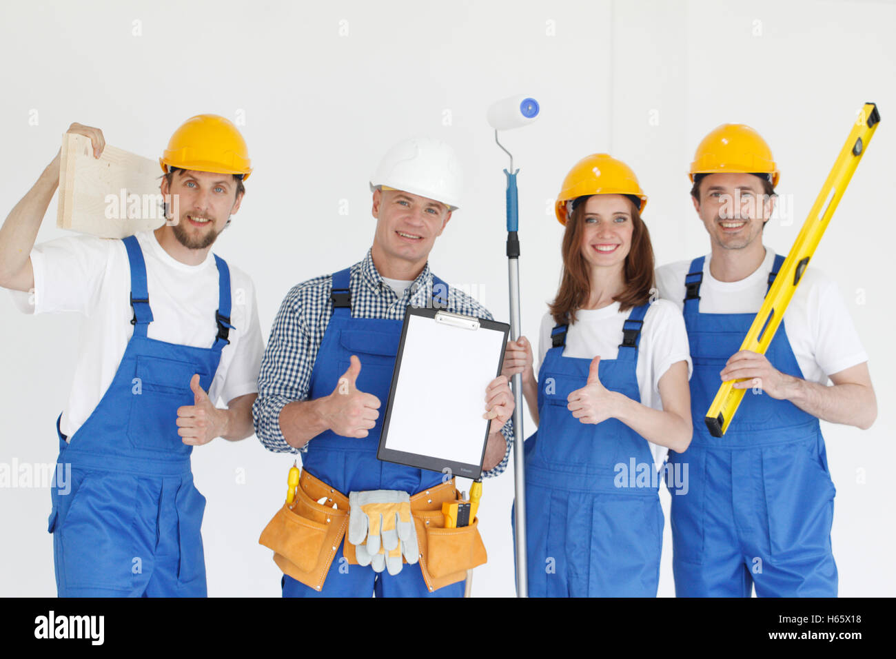 Team of happy workers with tools ready to work Stock Photo - Alamy