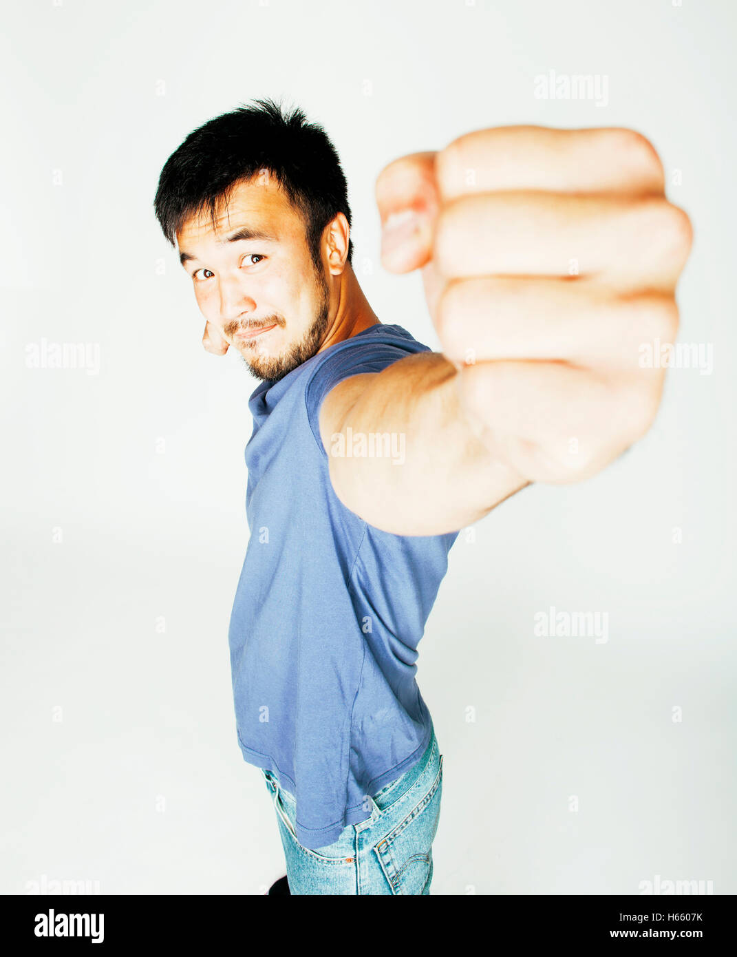 young cute asian man on white background gesturing emotional, pointing ...
