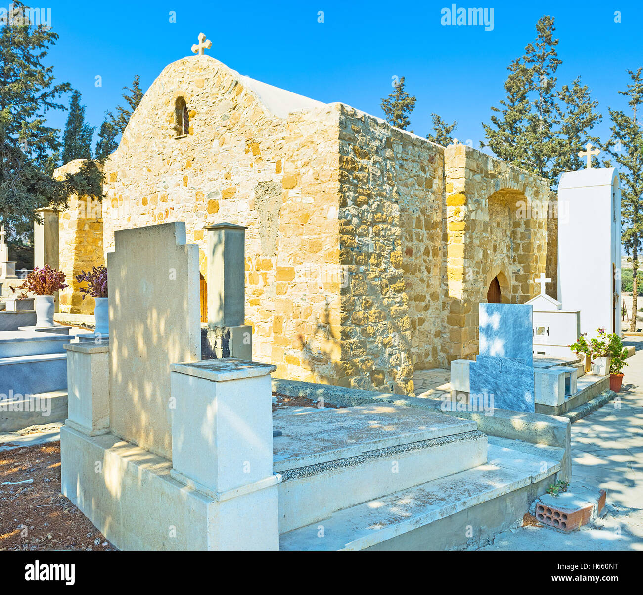 The small cemetery and the medieval stone church on the background ...